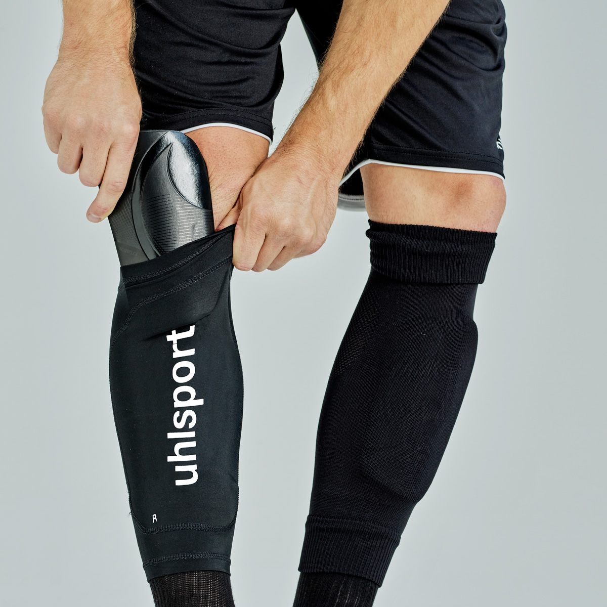 uhlsport GUARD SLEEVE in black | shin pad compression sock in the ...